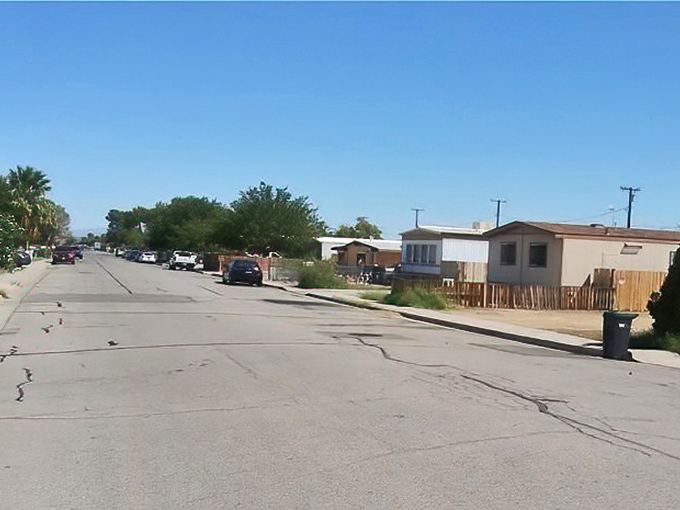 Modest homes line sun-baked streets where desert living means embracing simplicity, space, and the occasional crack in the asphalt.