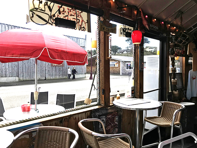 The casual window seating area offers the perfect backdrop for seafood contemplation, with red pendant lights warming the maritime atmosphere.