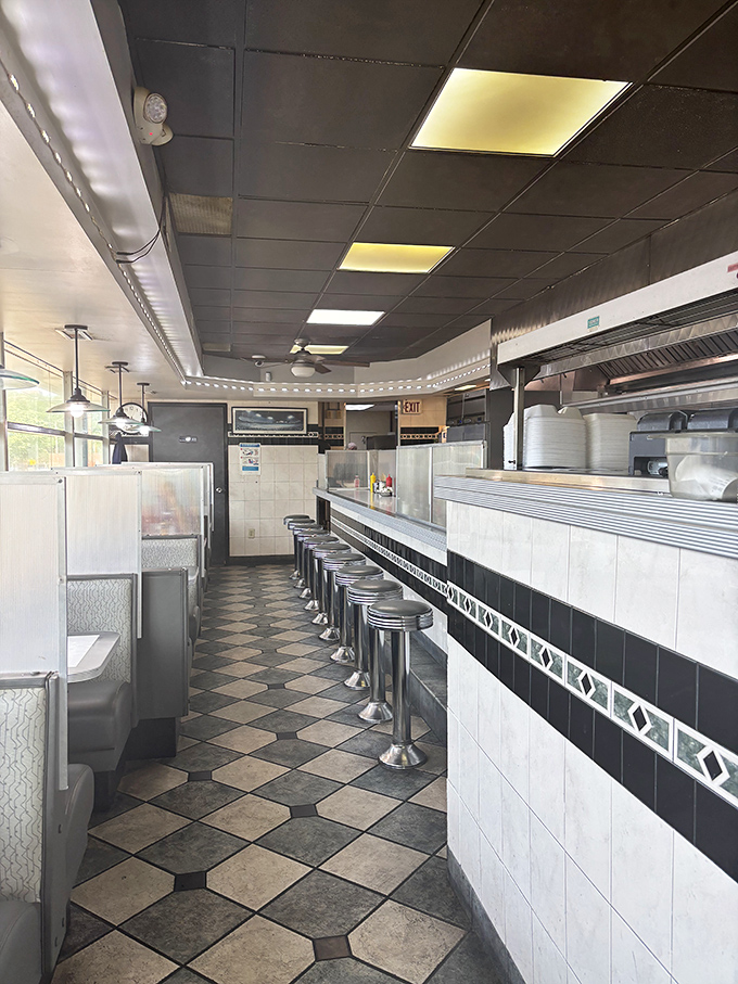 The classic diner aisle – where servers have perfected the art of balancing five plates while dodging fellow staff in a choreographed kitchen dance.