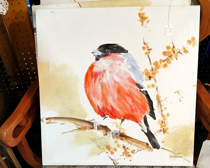 A delicate watercolor bullfinch perches eternally on its branch. Someone's artistic talent now waits to grace your living room wall.