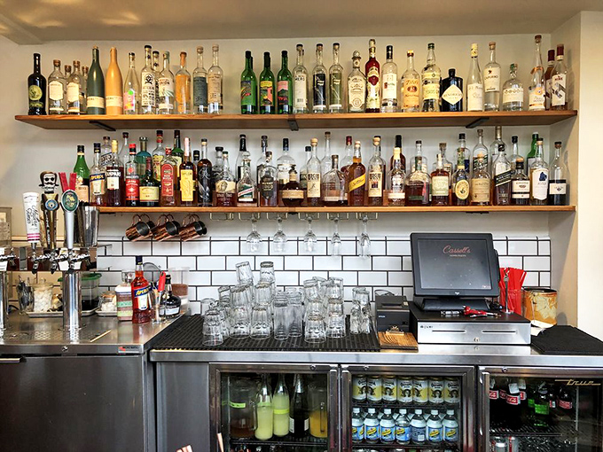 The bar shelves look like a liquid library of possibilities. Cocktails and burgers – proof that sometimes the best pairings aren't on wine lists.