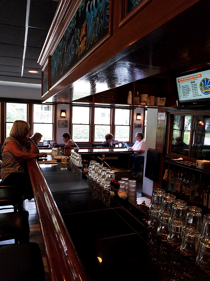 The bar at Jake's—where locals gather, glasses clink, and the bartender probably knows if you prefer lemon or lime before you even ask.