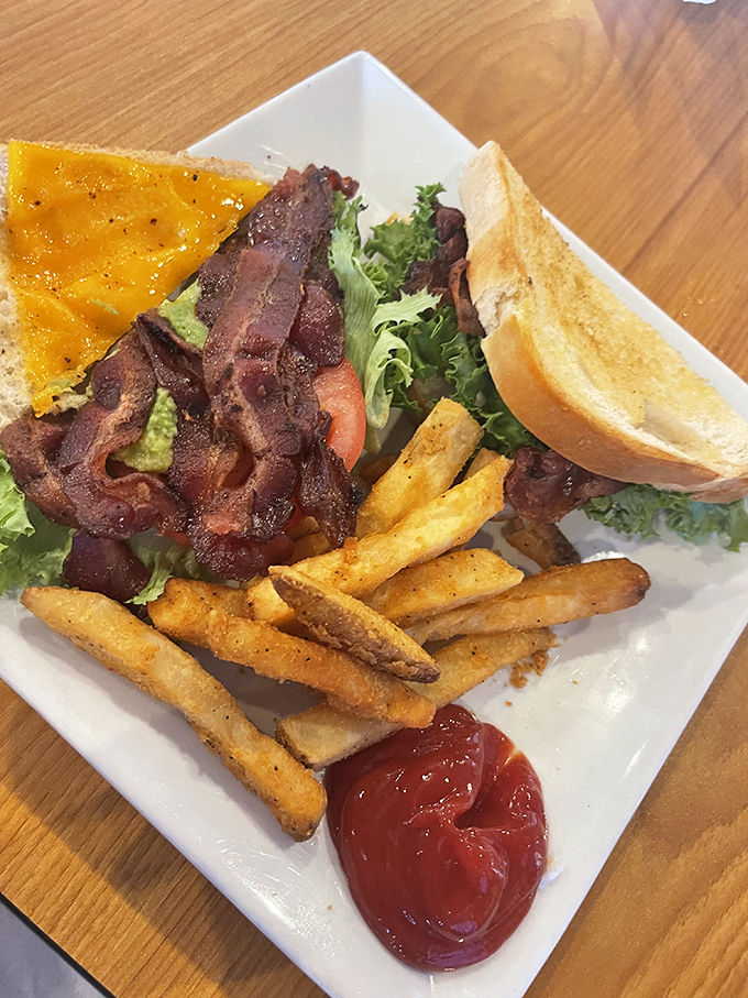 This towering BLT sandwich stacks crispy bacon, fresh lettuce, and ripe tomatoes into pure sandwich poetry.