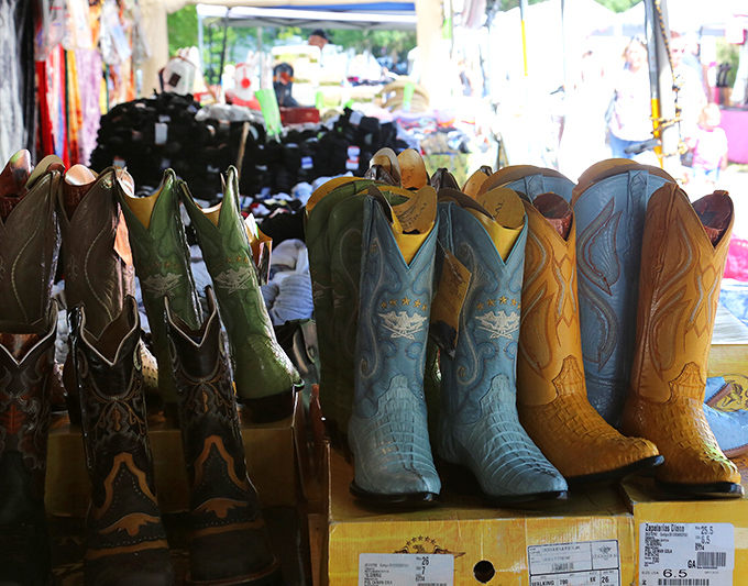 Cowboy boots lined up like hopeful contestants in a beauty pageant. Each pair silently whispering, "I could change your life," and they're not entirely wrong.