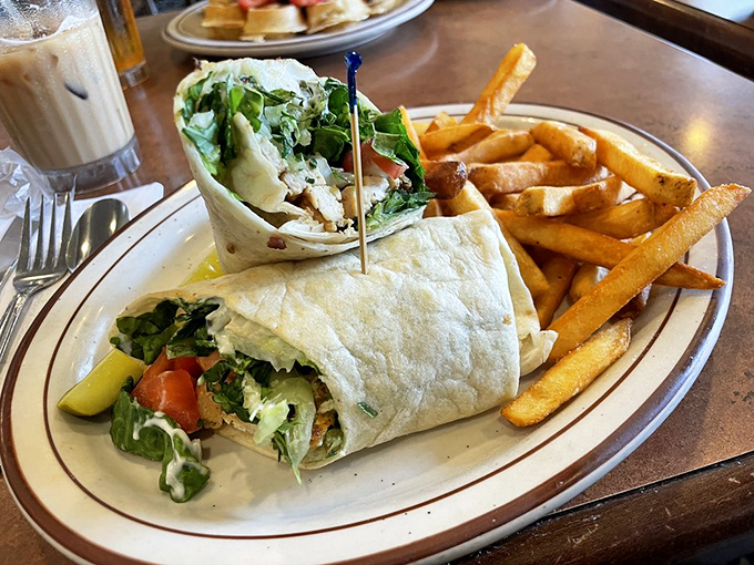 This wrap isn't just a meal, it's an edible architectural achievement – crisp lettuce, tender chicken, and fresh veggies embraced by a warm tortilla.