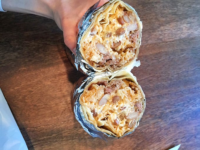 Behold the carnitas burrito in its natural state: cross-sectioned to reveal the perfect marriage of meat, rice, and cheese in tortilla harmony.