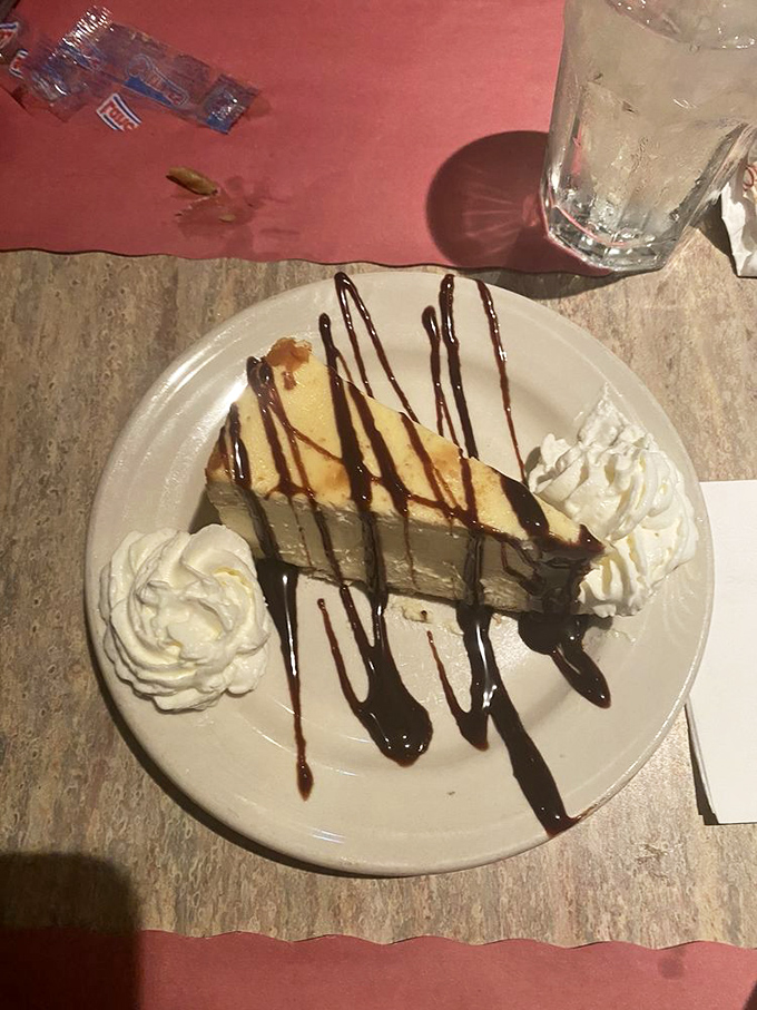 Cheesecake drizzled with chocolate that would make angels weep. That perfect slice represents everything right with the dessert world. 
