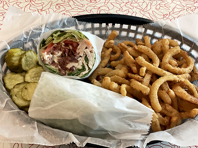 Wrap artistry at its finest. Crispy onion rings and pickle chips provide the perfect textural contrast to this handheld masterpiece.