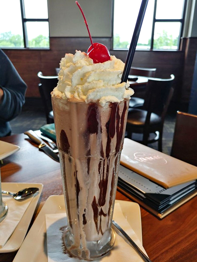 This isn't just a milkshake; it's a skyscraper of creamy indulgence topped with enough whipped cream to make a dairy cow proud.