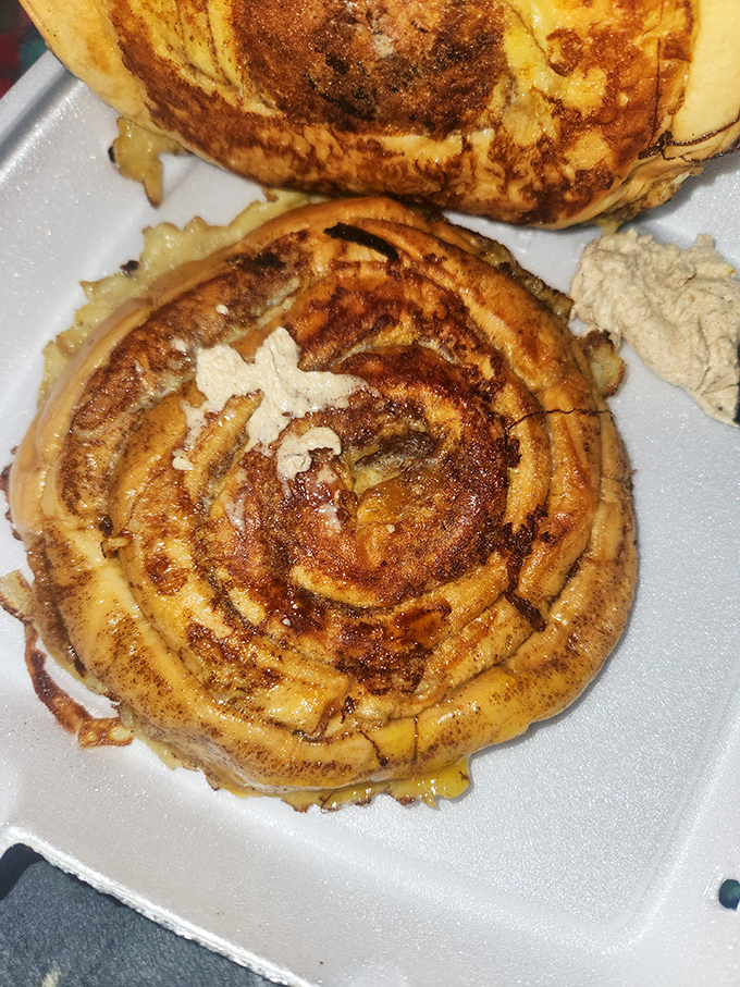 This cinnamon roll doesn't spiral, it hypnotizes. Butter melting into those warm, spiced crevices is breakfast theater at its finest.