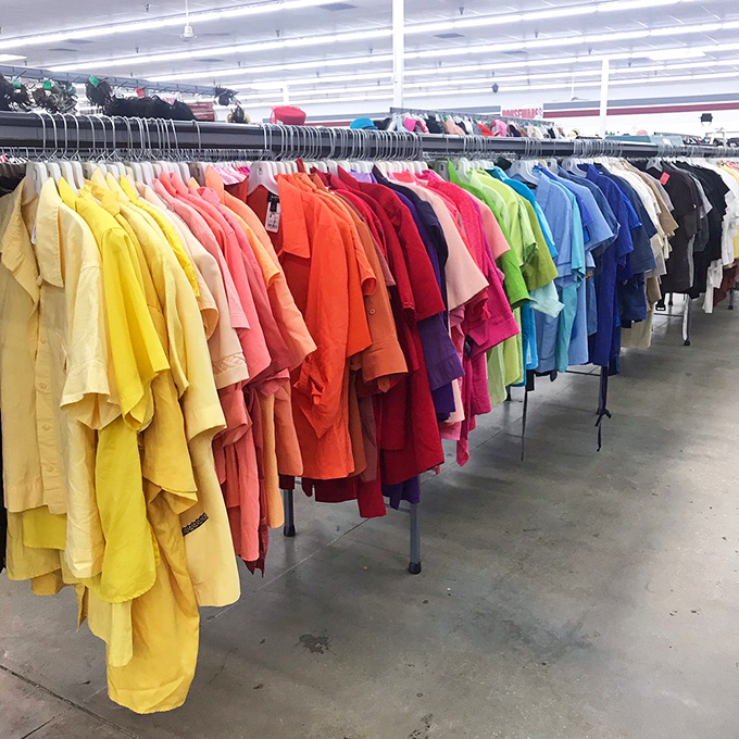 A spectrum of shirts arranged by color creates an Instagram-worthy rainbow of fashion possibilities. Marie Kondo would approve of this organizational joy.