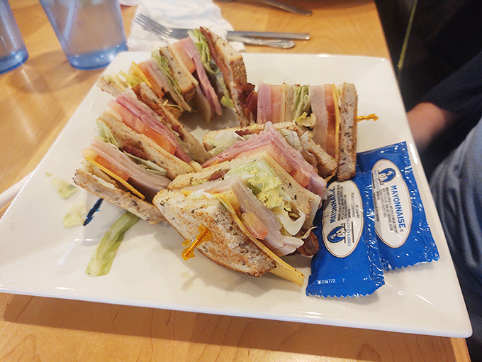 This club sandwich stands tall and proud, layers stacked with military precision. The bread-to-filling ratio is nothing short of architectural genius.