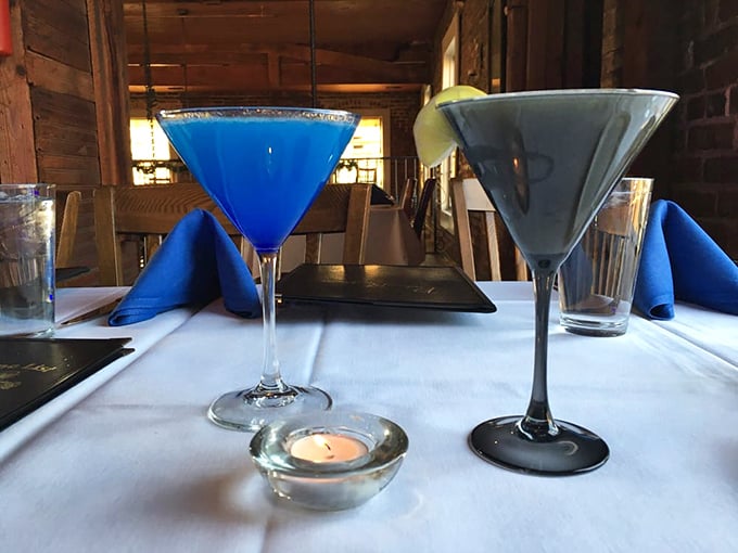 Blue cocktails that would make Sinatra proud sit elegantly on white tablecloths. That little candle isn't just for ambiance &ndash; it's witnessing liquid art.