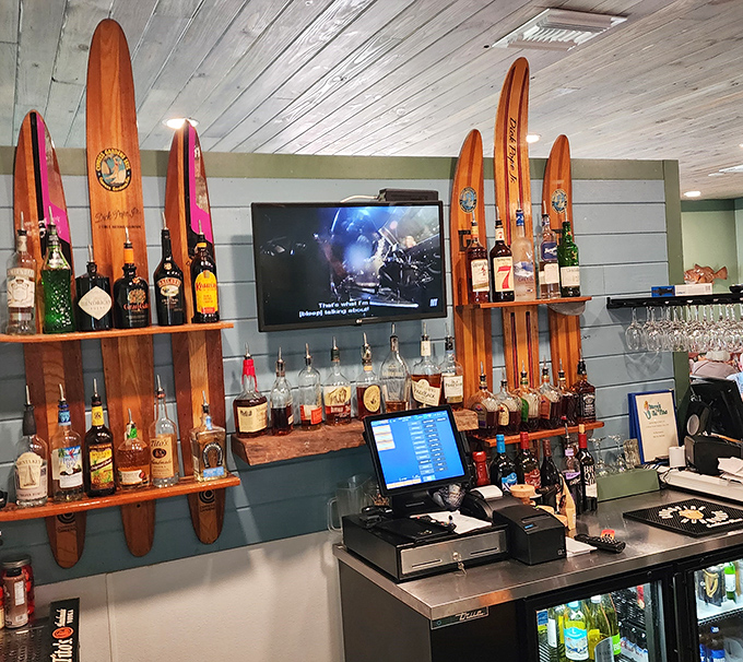 The bar area, where vintage water skis meet top-shelf spirits, creating that uniquely Florida vibe that says "we take our fun as seriously as our seafood."