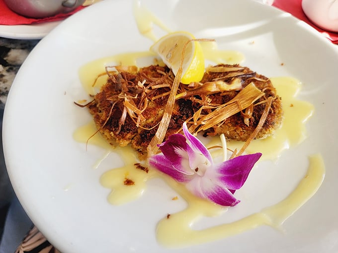 This crab cake wears a crispy crown of delicate fried leeks. Minimal filler, maximum flavor&mdash;the way crab cakes were meant to be enjoyed.