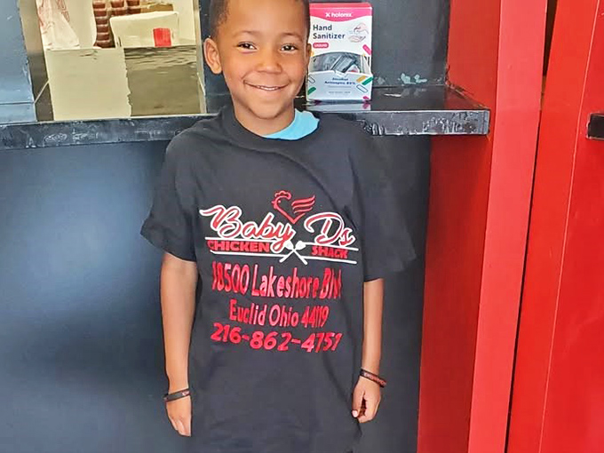 Young ambassador sporting the Baby D's uniform, proof that good taste starts at any age.