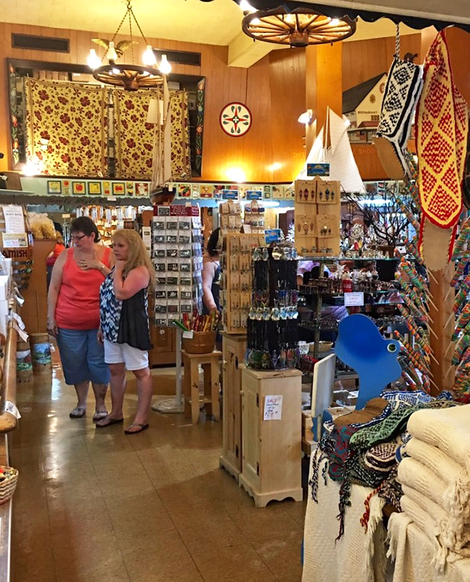 Treasure hunters exploring aisles filled with colorful quilts and handcrafted souvenirs. The wagon wheel chandeliers overhead are just the cherry on this Amish sundae.