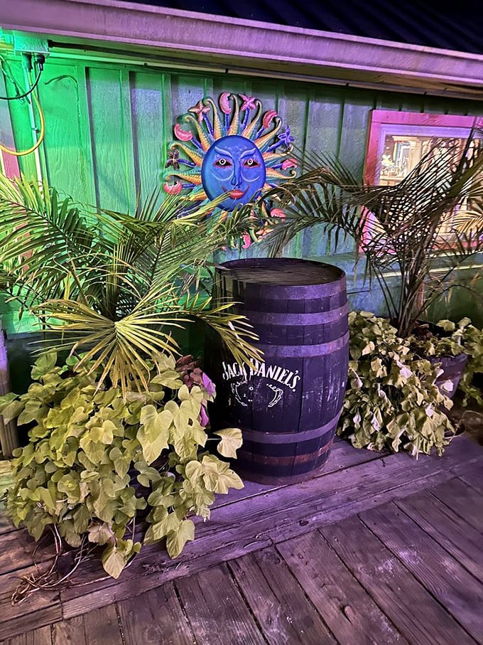 Tropical meets nautical with this whimsical sun decoration, Jack Daniel's barrel, and lush plants creating a perfect Eastern Shore vibe.