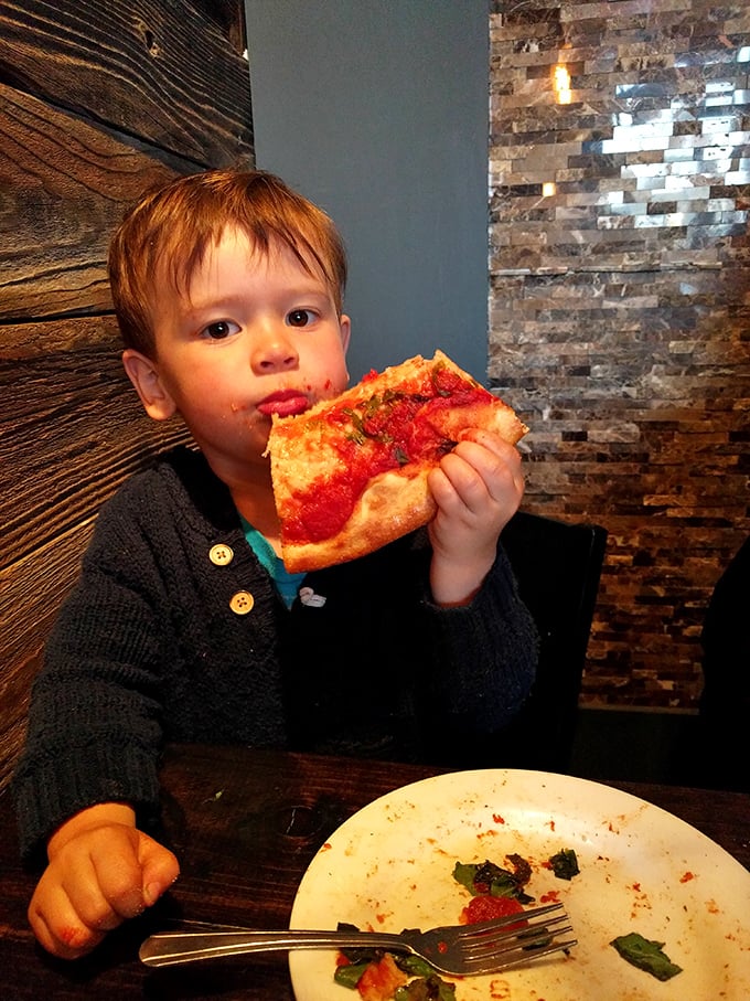 The universal truth of great pizza: it creates the same expression of pure joy on every face, regardless of age.