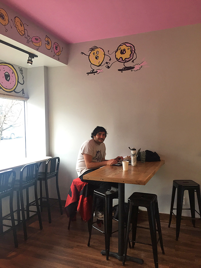 The simple joy of a table by the window, a hot coffee, and donuts that happen to be saving the planet one bite at a time.