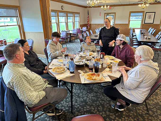 Where strangers become friends over pie and coffee. Notice how nobody's looking at their phones? That's the magic of real conversation and comfort food.