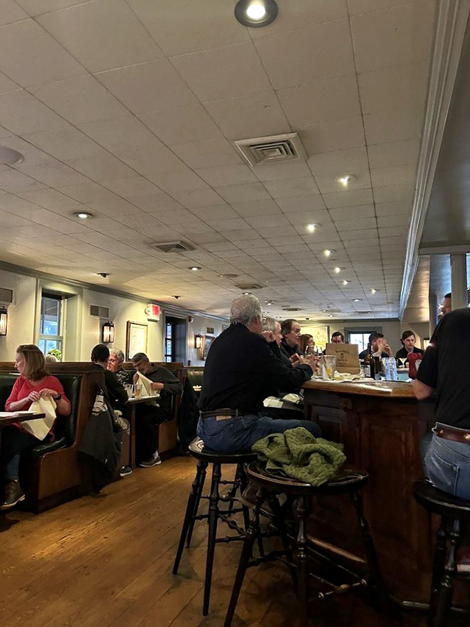 The bar area buzzes with the energy of regulars and newcomers alike, where stories flow as freely as the drinks in this living room away from home.