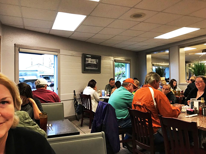 The true measure of a great local spot: tables filled with people who look like they've been coming here for decades. Those orange shirts aren't coincidental&mdash;they're loyal customers.
