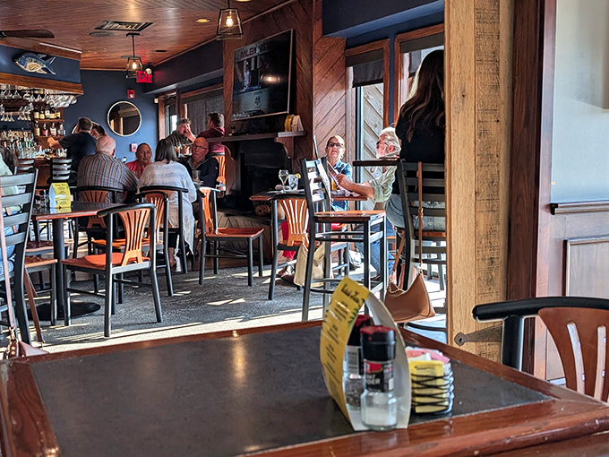The bar area buzzes with locals and visitors alike, sharing the universal language of "Did you try the crab cakes yet?" 