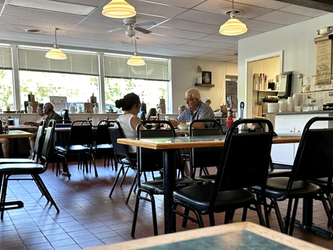 Morning light streams through windows as diners settle in, creating that perfect small-town tableau where coffee flows and conversation blooms.