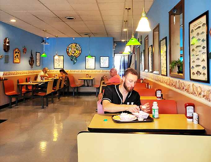 Diners enjoying the simple pleasure of fresh seafood in unpretentious surroundings. That focused expression says it all&mdash;good food requires your full attention.