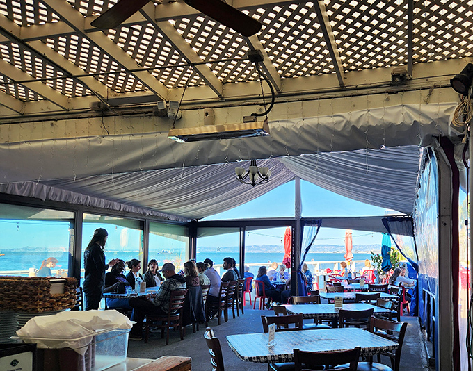 White tent ceilings and bay windows transform an ordinary meal into something magical, where conversations flow as freely as the water views.