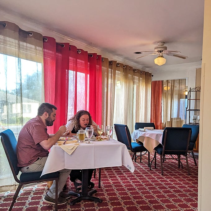 Colorful curtains and intimate lighting create the perfect backdrop for conversations that linger long after dinner ends.