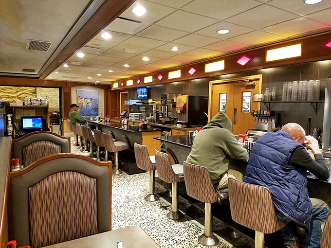 The counter seating&mdash;where diner magic happens. Where regulars become family and solo diners find community over coffee and pie.