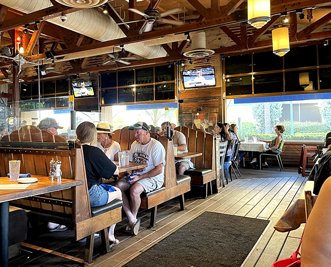 Wooden booths worn smooth by happy diners frame conversations that flow as easily as the wine. Notice how nobody's looking at their phones?