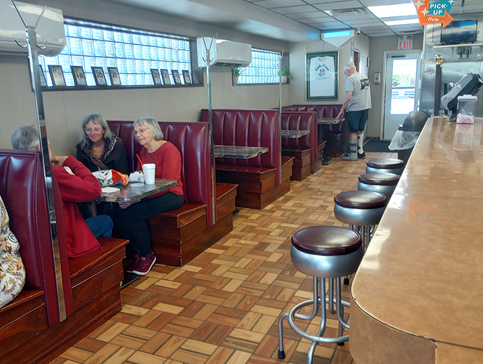 Red vinyl booths: where strangers become neighbors and food becomes conversation. The backdrop to countless Greenville memories since forever.
