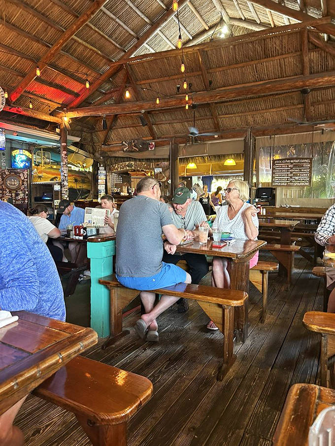 Under that soaring thatched ceiling, strangers become friends and friends become family. The picnic tables aren't just furniture&mdash;they're community builders.