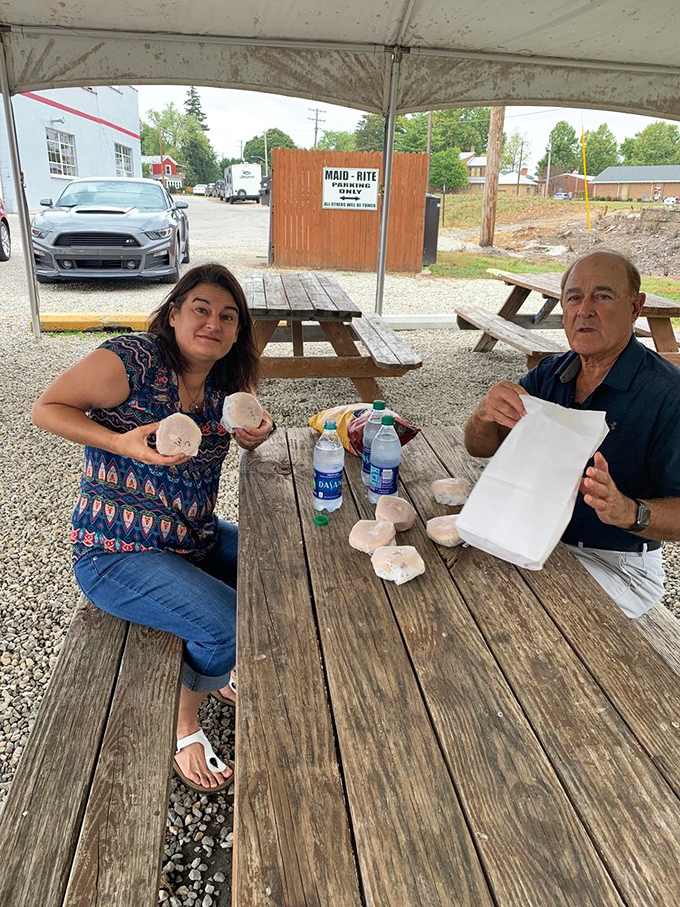 Outdoor picnic tables where strangers become friends over shared sandwich experiences. The universal language of "mmm" needs no translation.