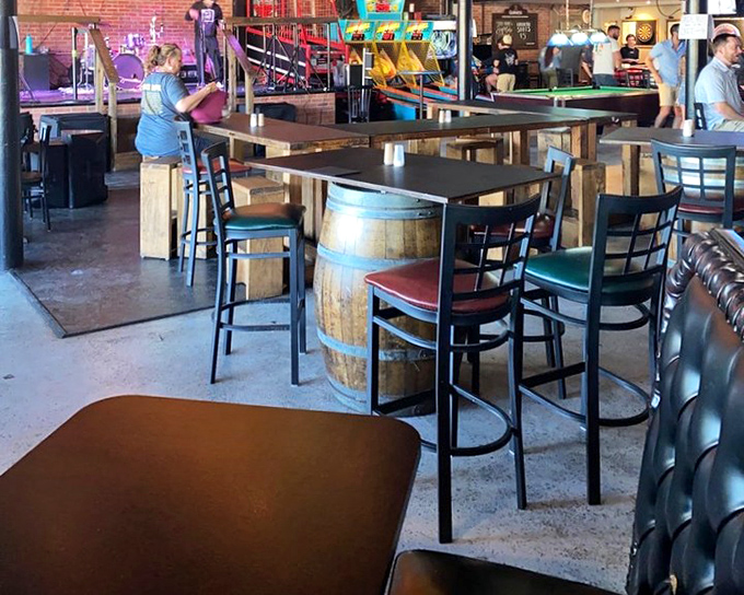 Barrel tables and high chairs create the perfect perch for barbecue contemplation. Notice the pool table waiting for post-meal recreation.