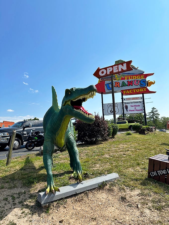 A prehistoric greeter stands guard near the entrance sign, reminding visitors that Uranus embraces all eras of history with equal enthusiasm and irreverence.