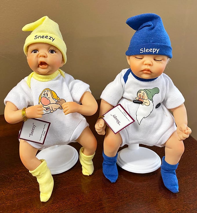 Sneezy and Sleepy dolls caught mid-nap, proving that even Disney's dwarfs need consignment shops for their retirement plans.