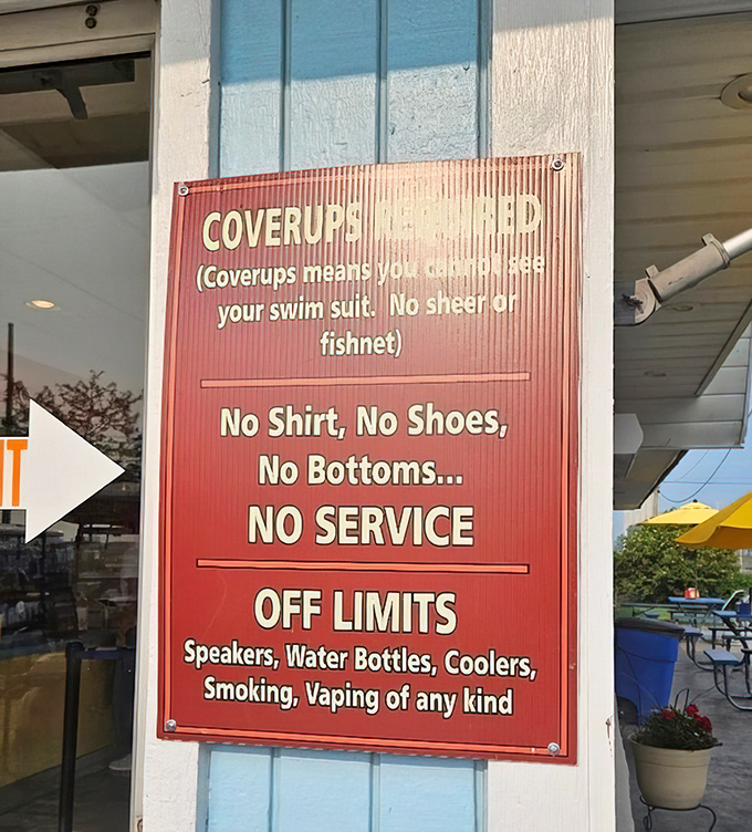 Rules with personality&mdash;the sign's humor softening its strict message about proper attire, proving even paradise needs some boundaries.