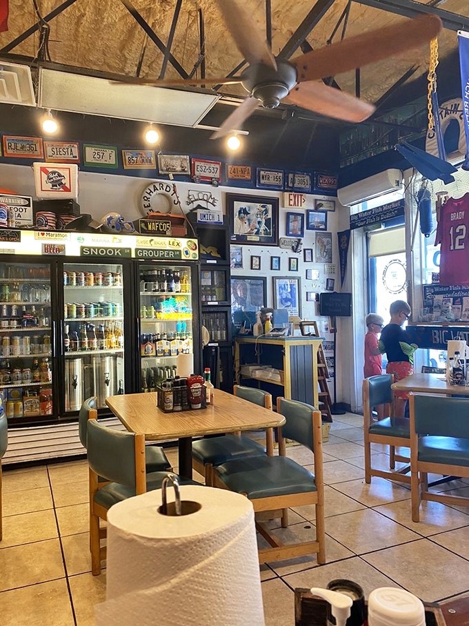 License plates and fishing memorabilia create the perfect backdrop for seafood feasting. This isn't decoration&mdash;it's a visual history of Florida's relationship with the water.