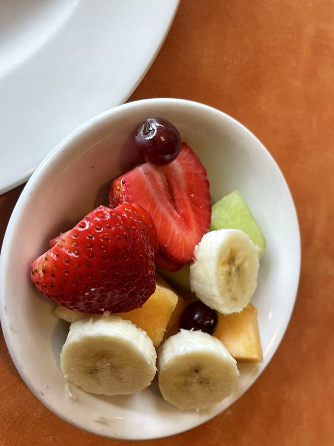A bowl of fresh fruit that actually looks like the pictures in health magazines. Nature's candy providing the illusion of breakfast virtue.