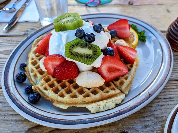 A waffle that's basically a fruit delivery system. Fresh berries and cream transform breakfast into something that feels both virtuous and decadent.