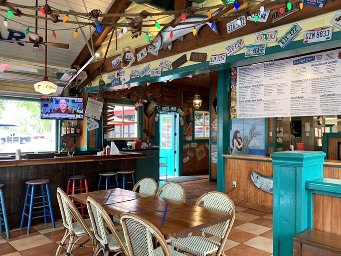 Colorful license plates and twinkling lights create the perfect backdrop for seafood indulgence. Nautical kitsch elevated to an art form.
