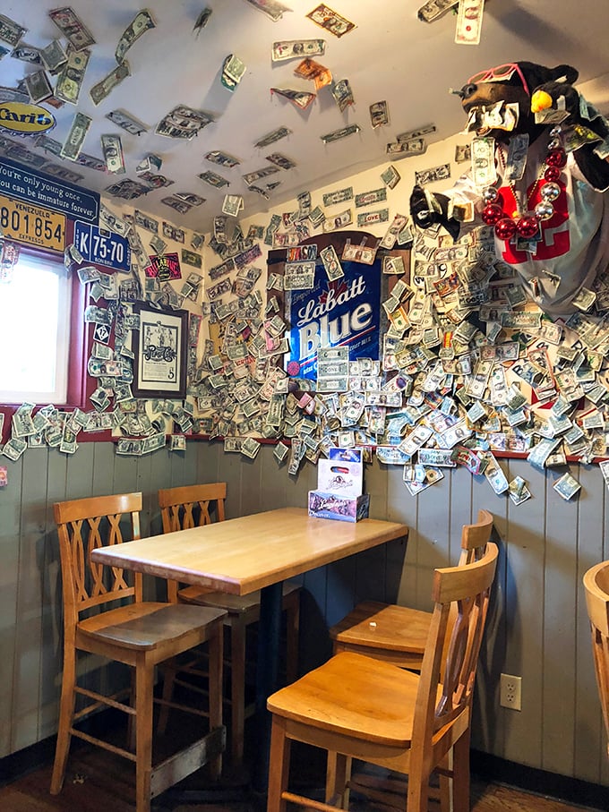 Dollar bills on the ceiling tell stories of satisfied customers who literally invested in the experience.