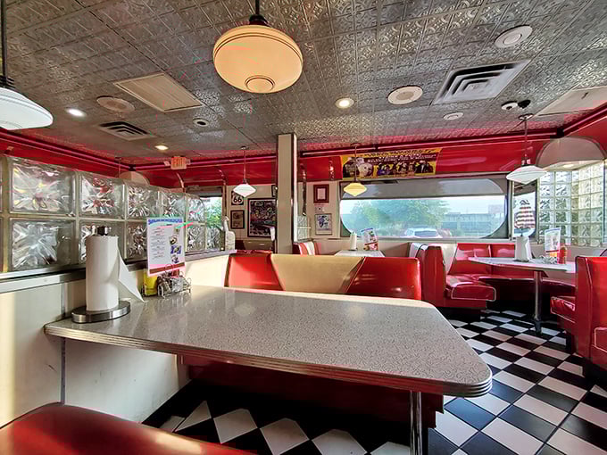 The classic diner layout: booths for privacy, counter for community, and enough chrome to see your reflection while you eat.