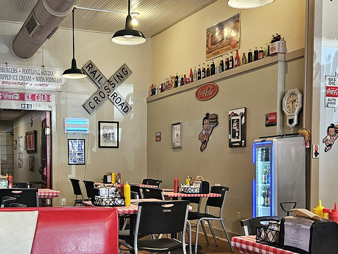 Railroad crossing signs and classic Americana create the perfect backdrop for comfort food conversations. Every inch of wall space tells a story.
