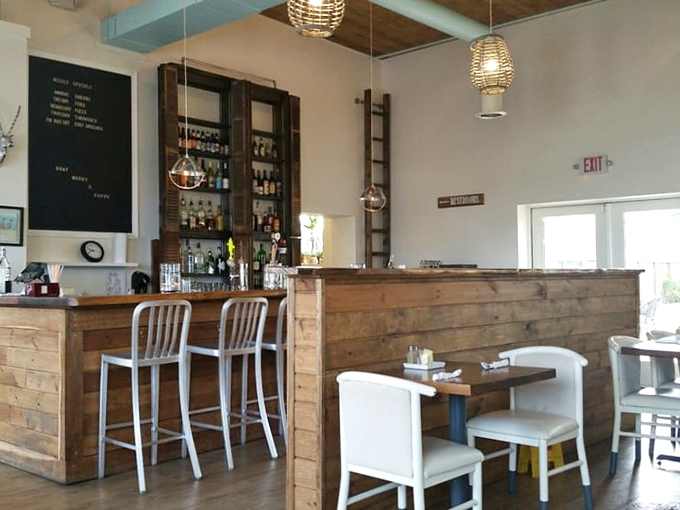 The bar area's rustic wooden panels and industrial-chic lighting create that rare sweet spot between "fancy enough for date night" and "comfortable enough for Tuesday lunch."