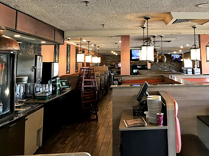 Copper pendant lights cast that perfect amber glow over wooden tables, creating the lighting directors at Hollywood would call "dinnertime magic."